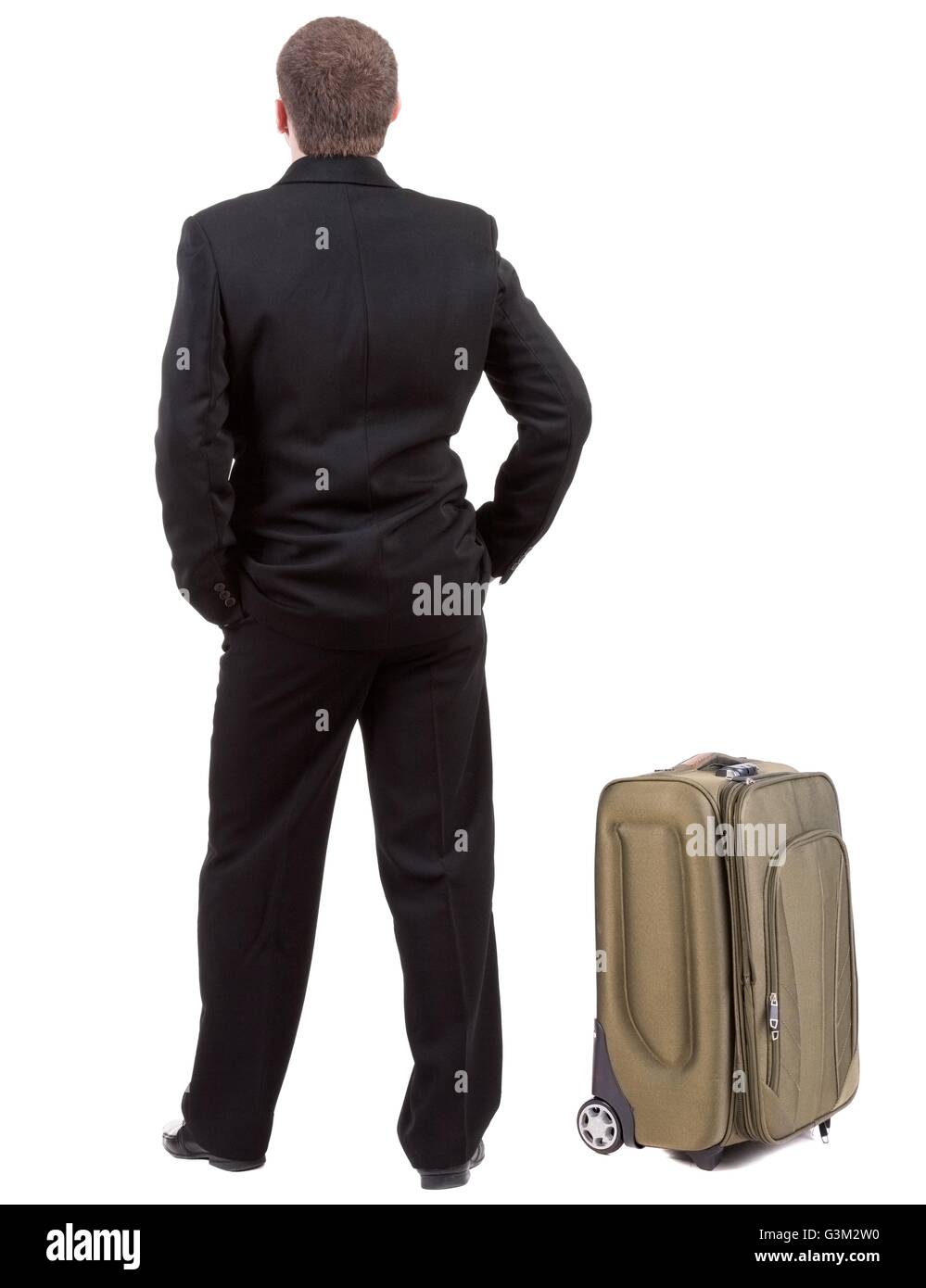 Back view of traveling busness man with suitcase looking up. Standing ...