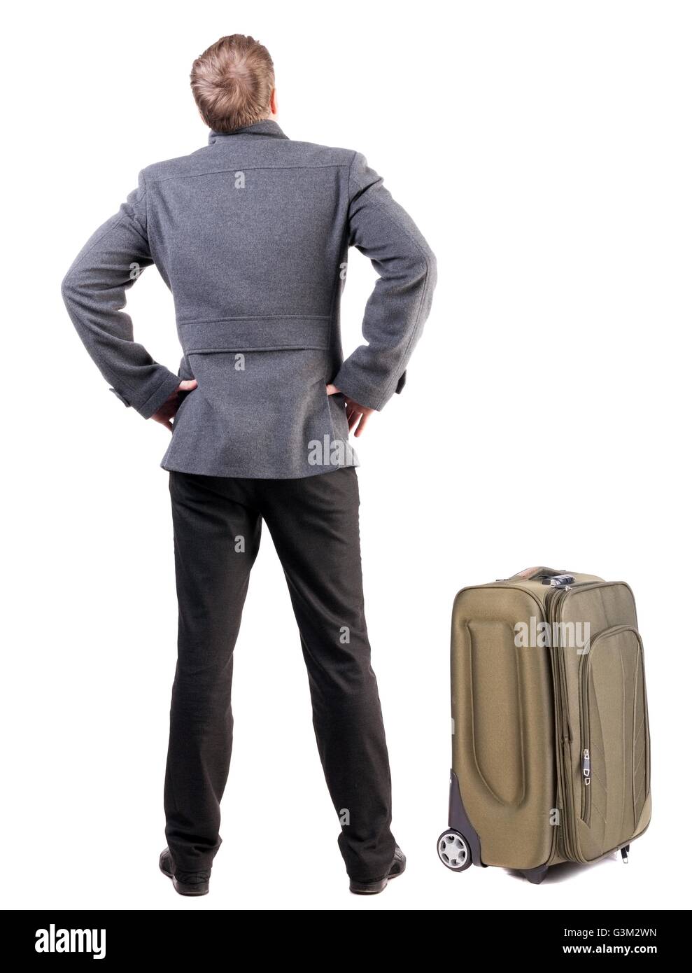 Back view of traveling busness man with suitcase looking up. Standing ...