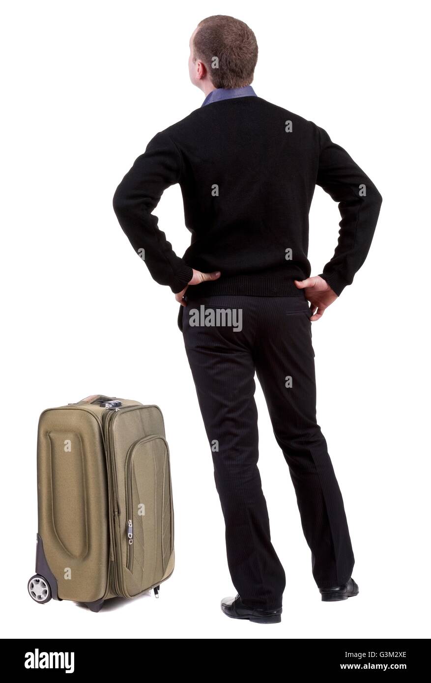 Back view of traveling busness man with suitcase looking up. Standing ...