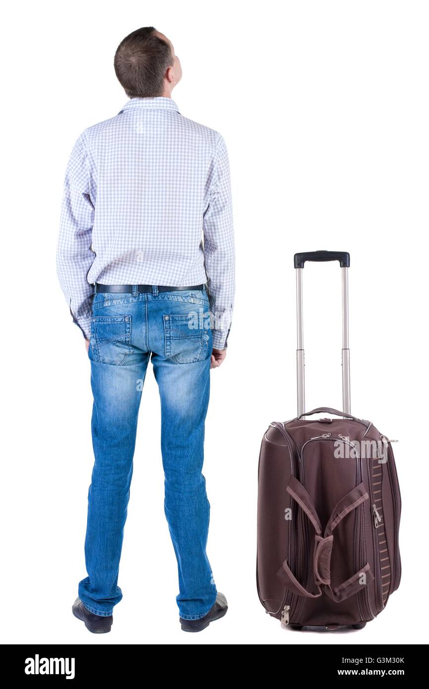 Back view of traveling busness man with suitcase looking up. Standing ...