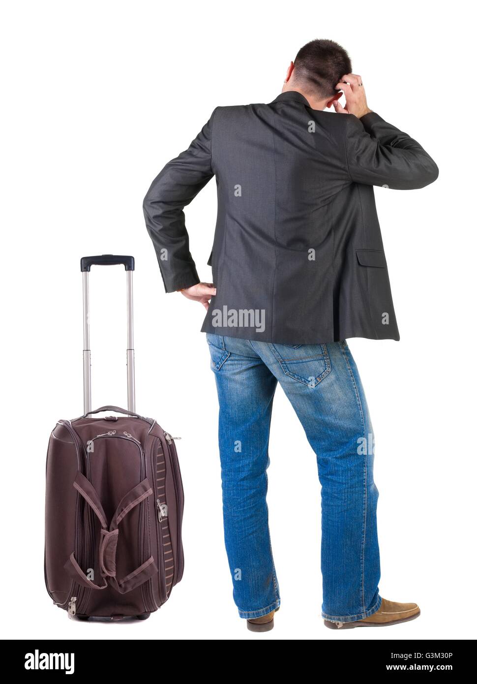Back view of traveling busness man with suitcase looking up. Standing ...
