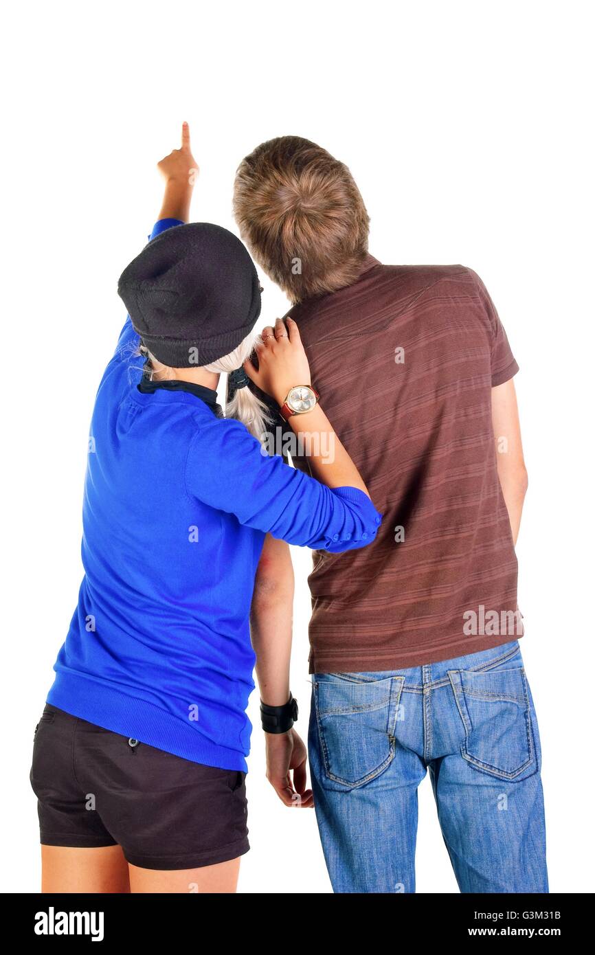 Backview of young couple interestedly looks at white. Rear view people ...