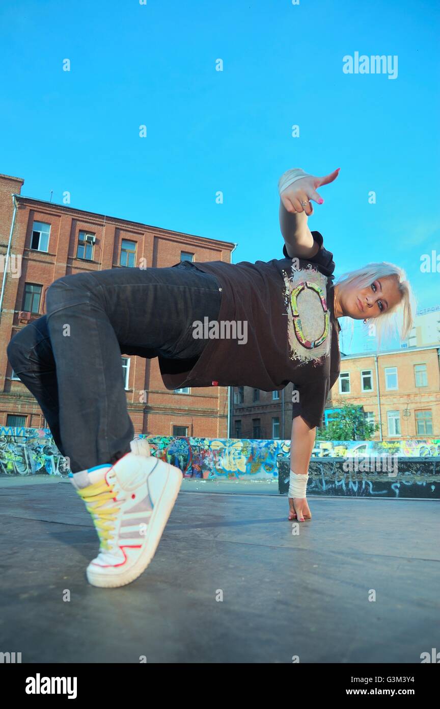 Girl break-dancer posing Stock Photo - Alamy