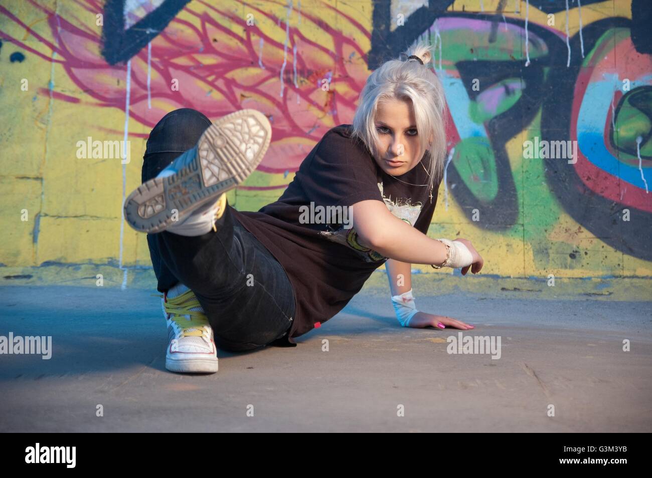 Girl break-dancer posing Stock Photo - Alamy