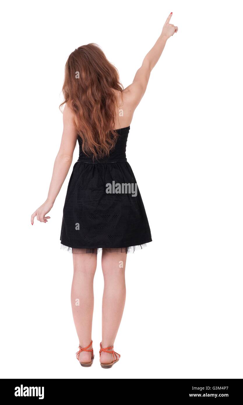 Back view of pointing woman. beautiful redhaired girl . girl shows ...