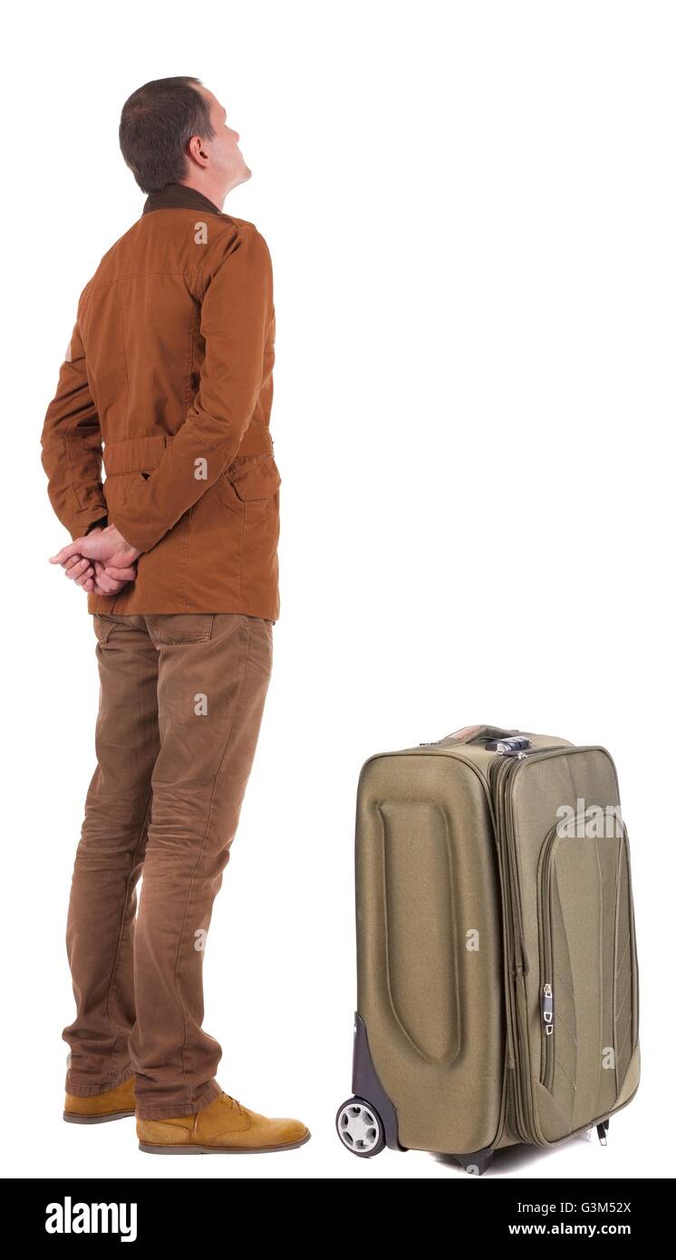 Back view of traveling busness man with suitcase looking up. Standing ...