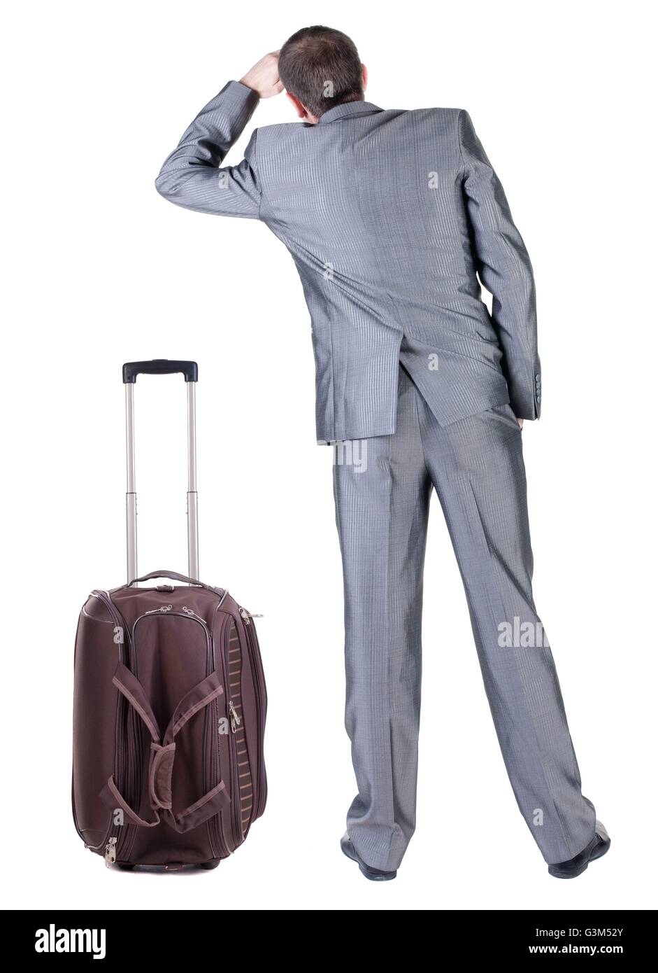 Back view of traveling busness man with suitcase looking up. Standing ...