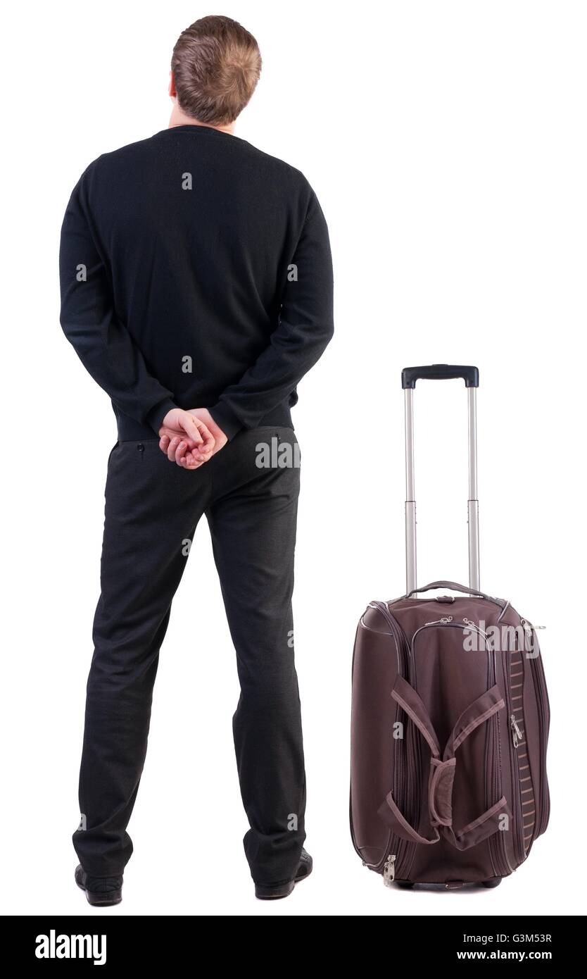 Back view of traveling busness man with suitcase looking up. Standing ...