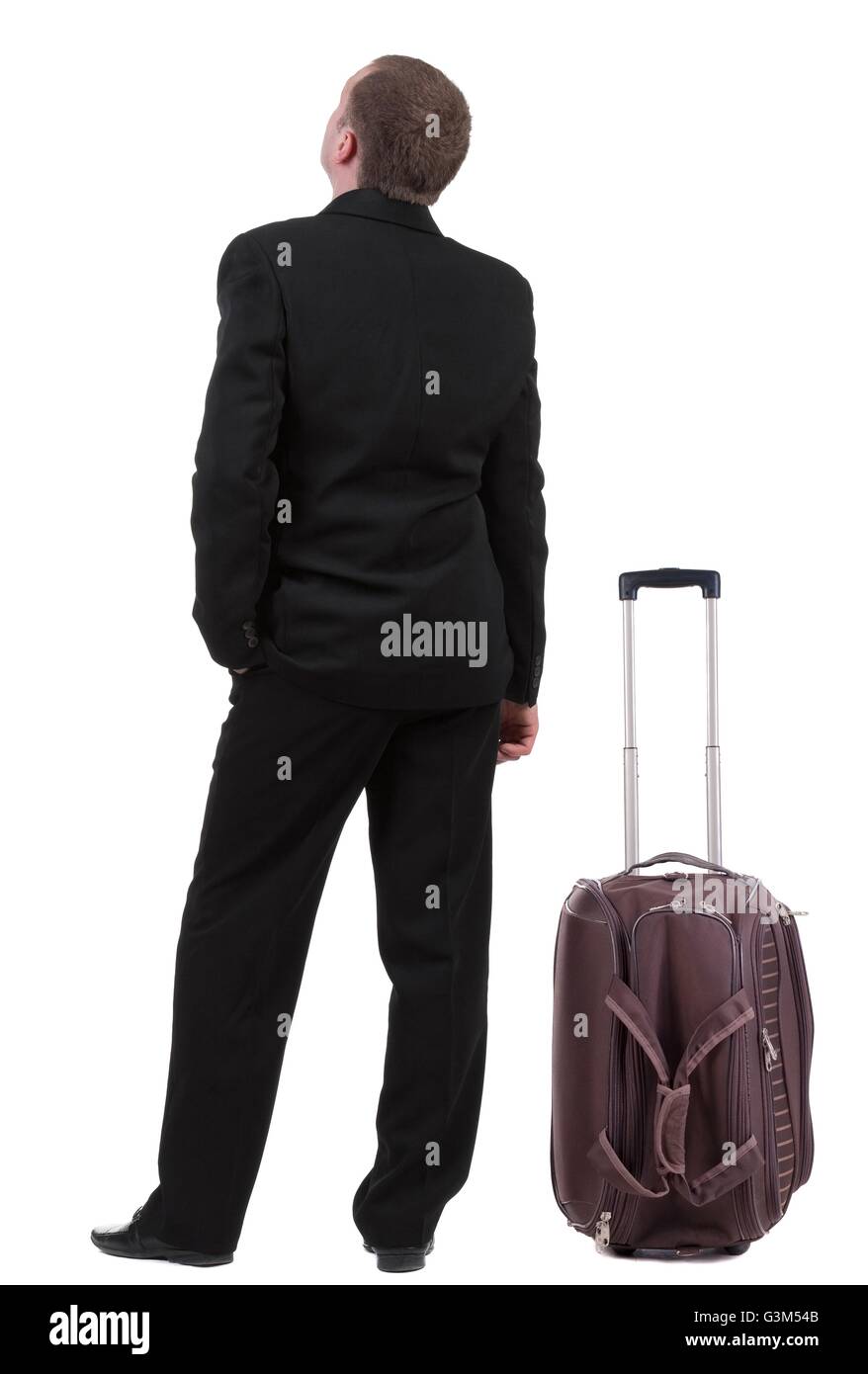 Back view of traveling busness man with suitcase looking up. Standing ...