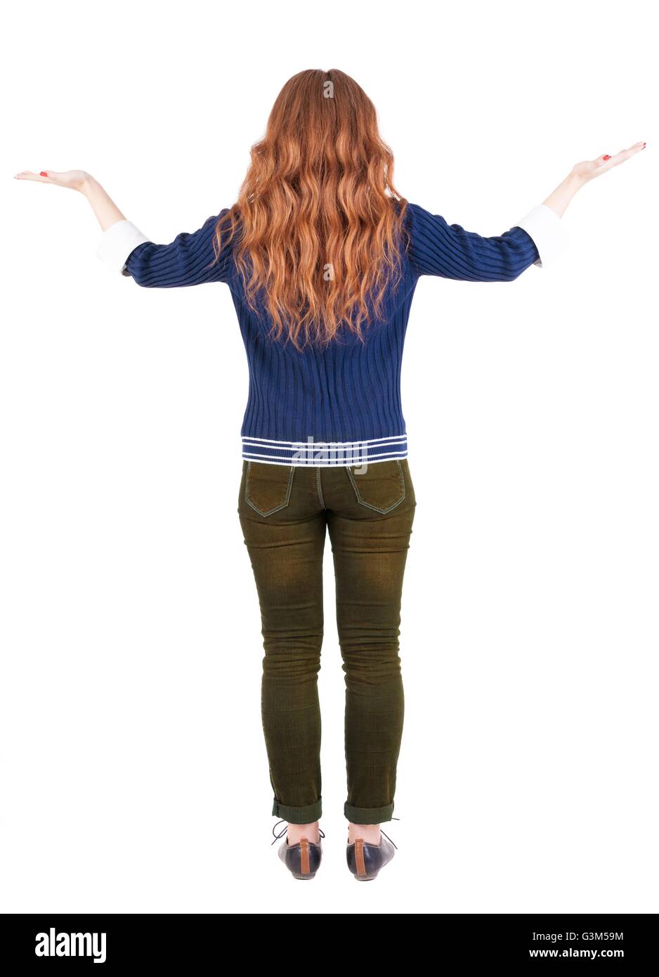 Back view of Beautiful woman looking at wall and Holds a hand up. Rear ...