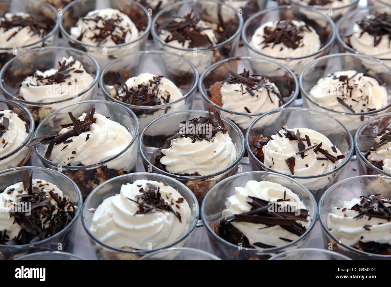 Whipped cream with chocolate on table in row Stock Photo - Alamy