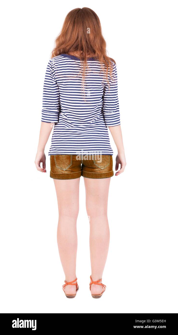 back view of standing young beautiful redhead woman. girl watching ...