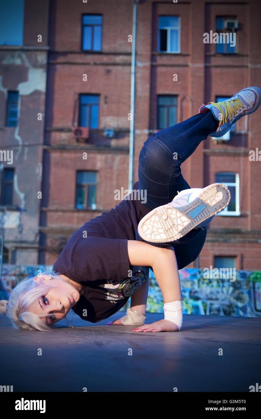 Girl break-dancer posing Stock Photo - Alamy