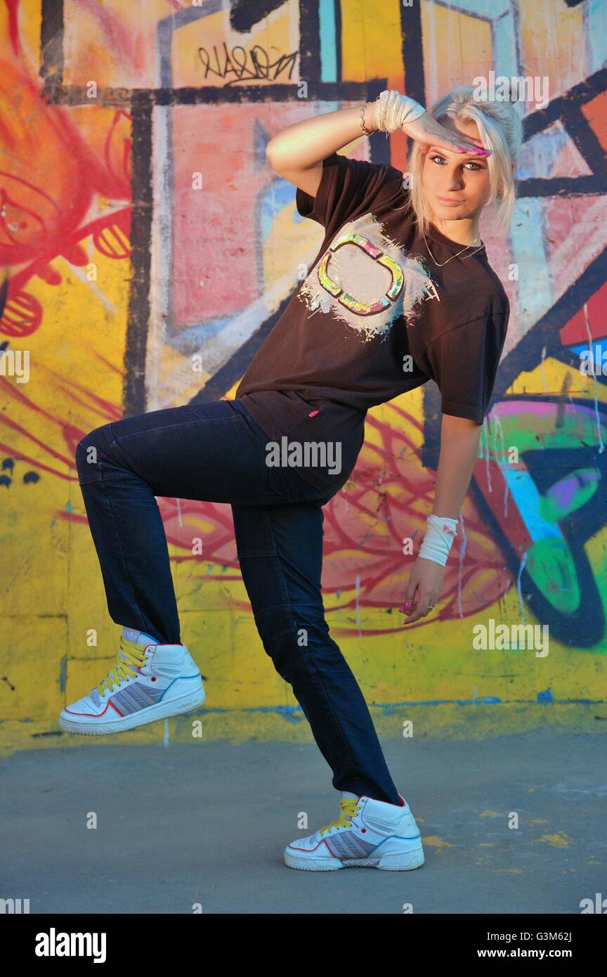 Girl break-dancer posing Stock Photo - Alamy