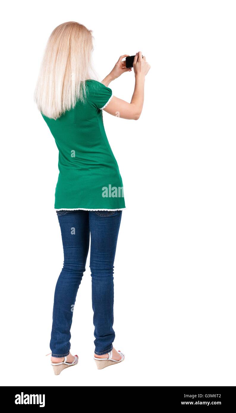 Back view of woman photographing. girl photographer in jeans. Rear view ...