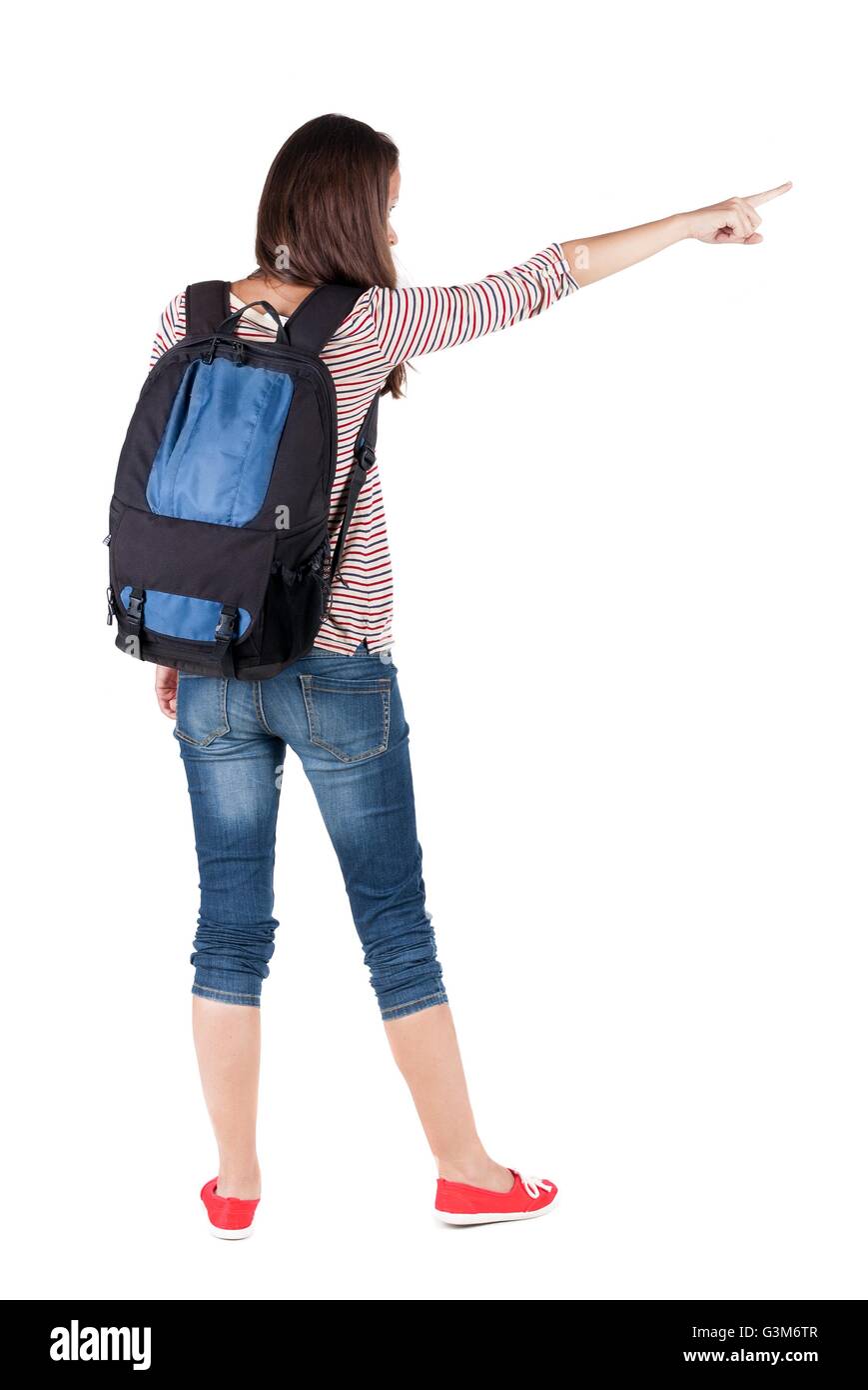 Back view of pointing woman with backpack looking up. Standing young ...