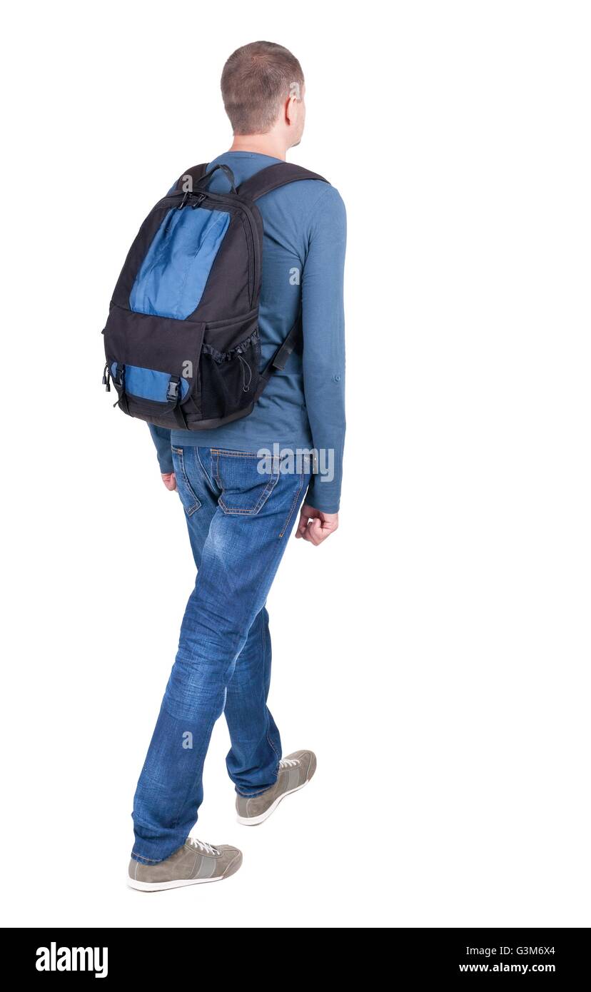 back view of walking man with backpack. brunette guy in motion ...