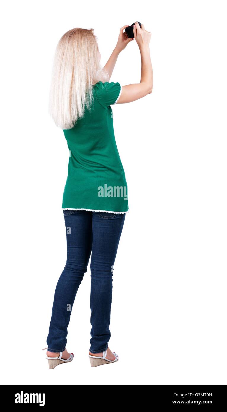 Back view of woman photographing. girl photographer in jeans. Rear view ...