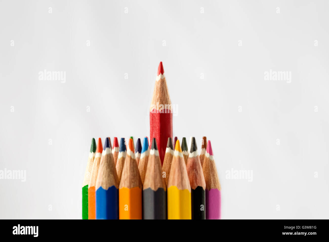 Group of colored pencils with the red standing above the rest depicting ...