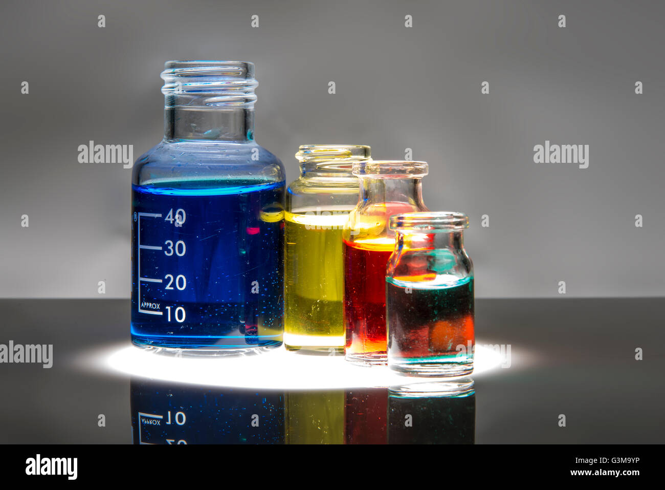 Set of laboratory bottles with color liquid Stock Photo - Alamy