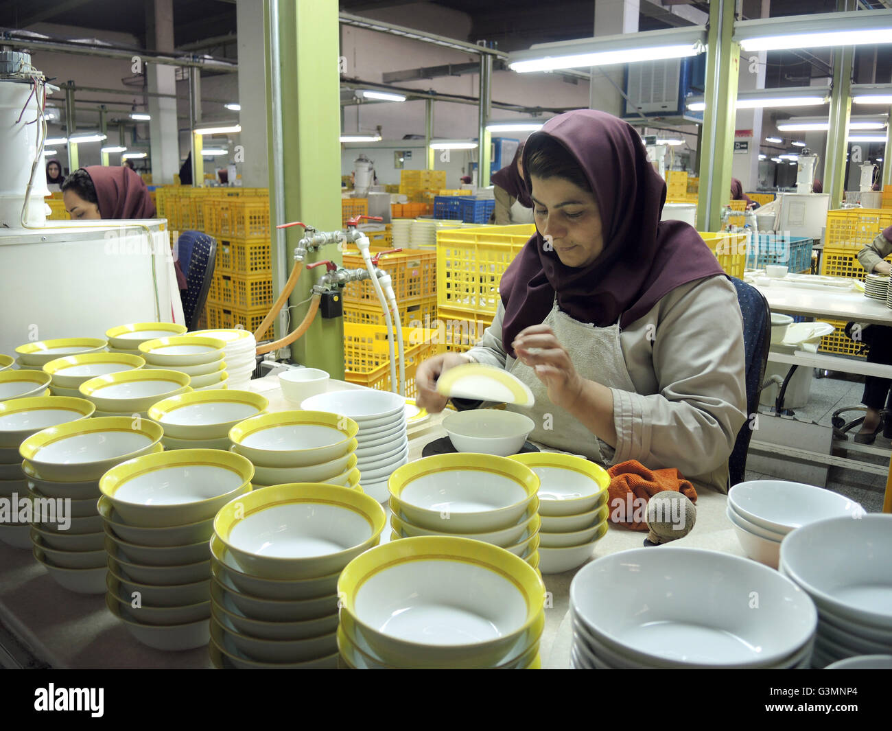 Isfahan, Iran. 01st June, 2016. A worker decorates bowls in a plant of ...