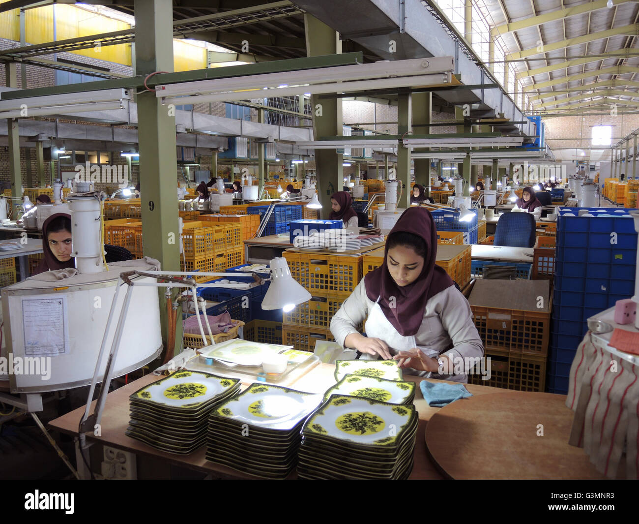 Isfahan, Iran. 01st June, 2016. A worker decorates plates in a plant of ...