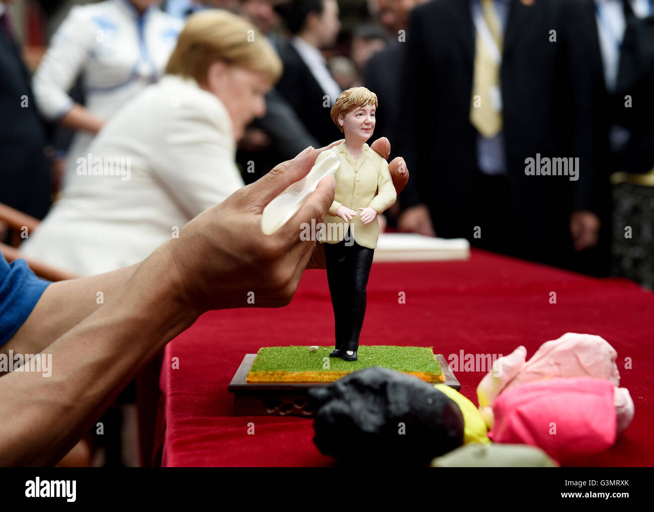 Shenyang, Germany. 14th June, 2016. An artist shapes the German ...
