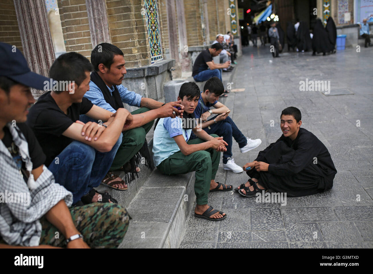 Tehran, Iran. 13th June, 2016. Local youth sit in front of a mosque in ...