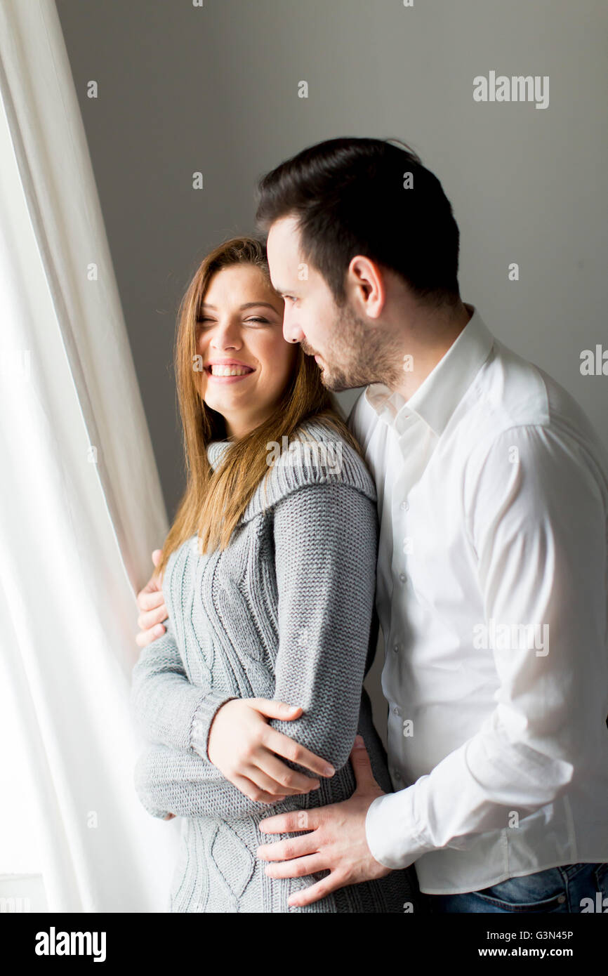 Loving couple by the window Stock Photo - Alamy