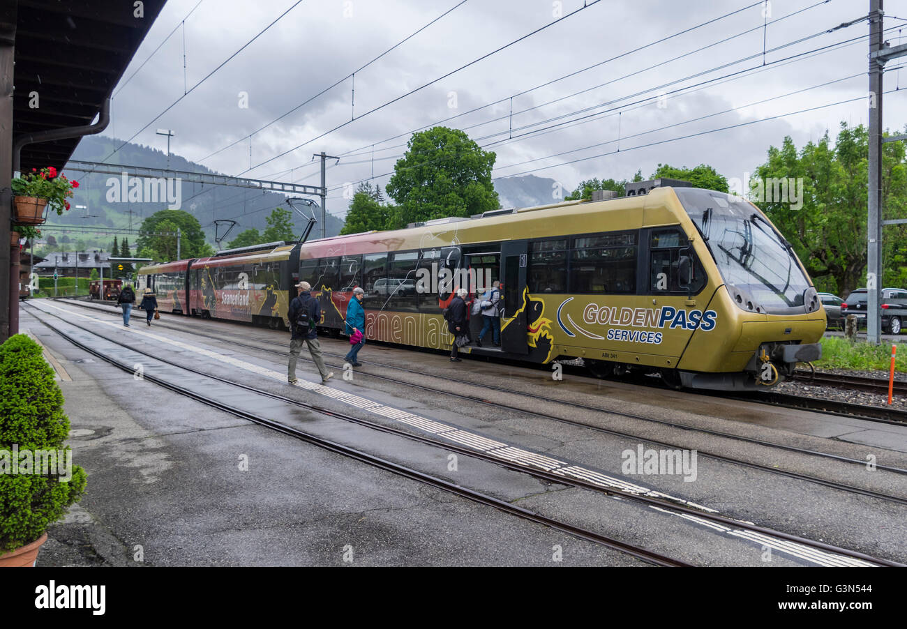 Passengers boarding a GoldenPass Line train of the MOB Montreux ...