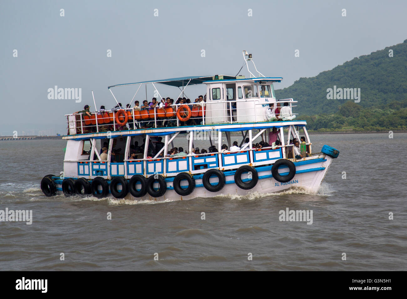 MUMBAI, INDIA - OCTOBER 11, 2015: Unidentified people on a ferry. Water ...