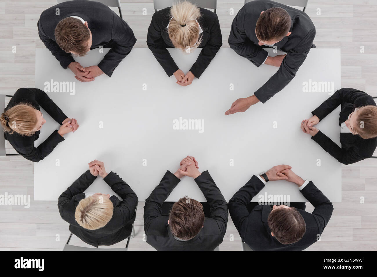 Diverse business people sitting around the table on a meeting Stock ...