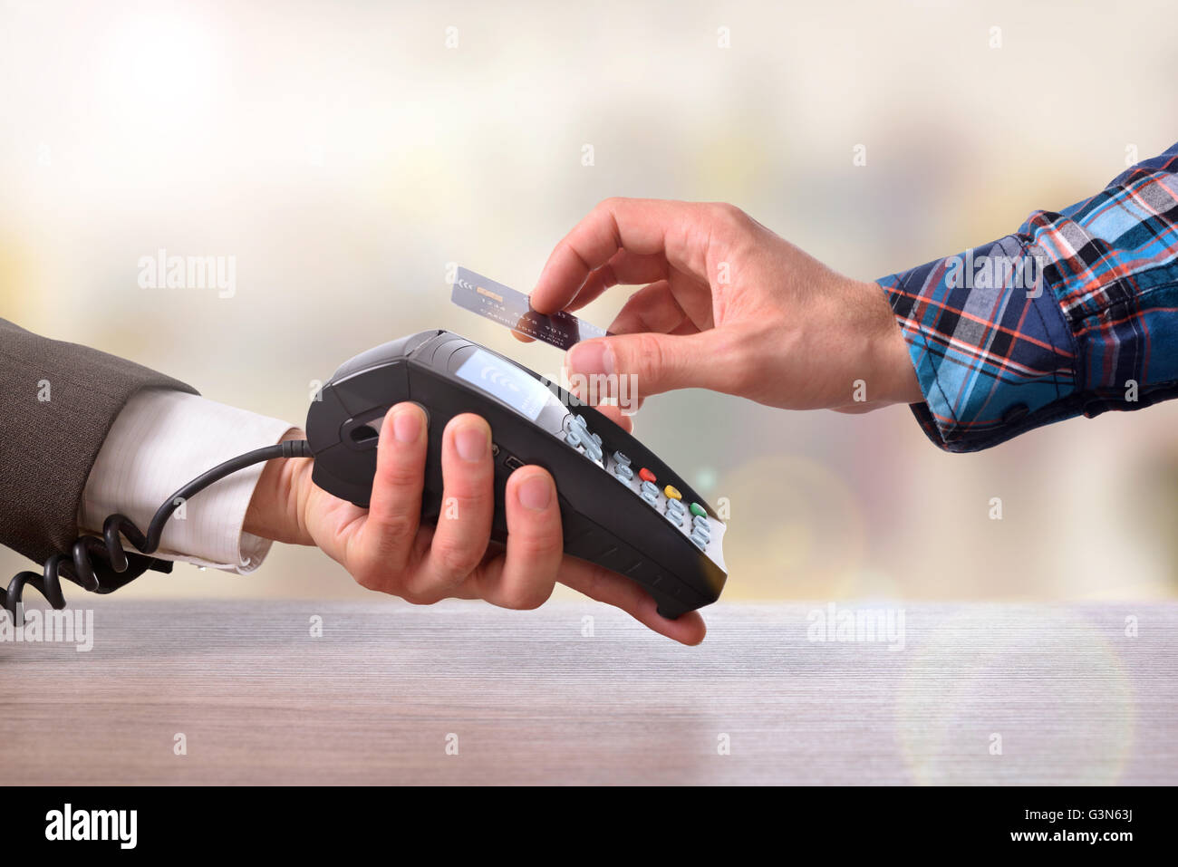 Customer paying a merchant with contactless card with NFC technology ...