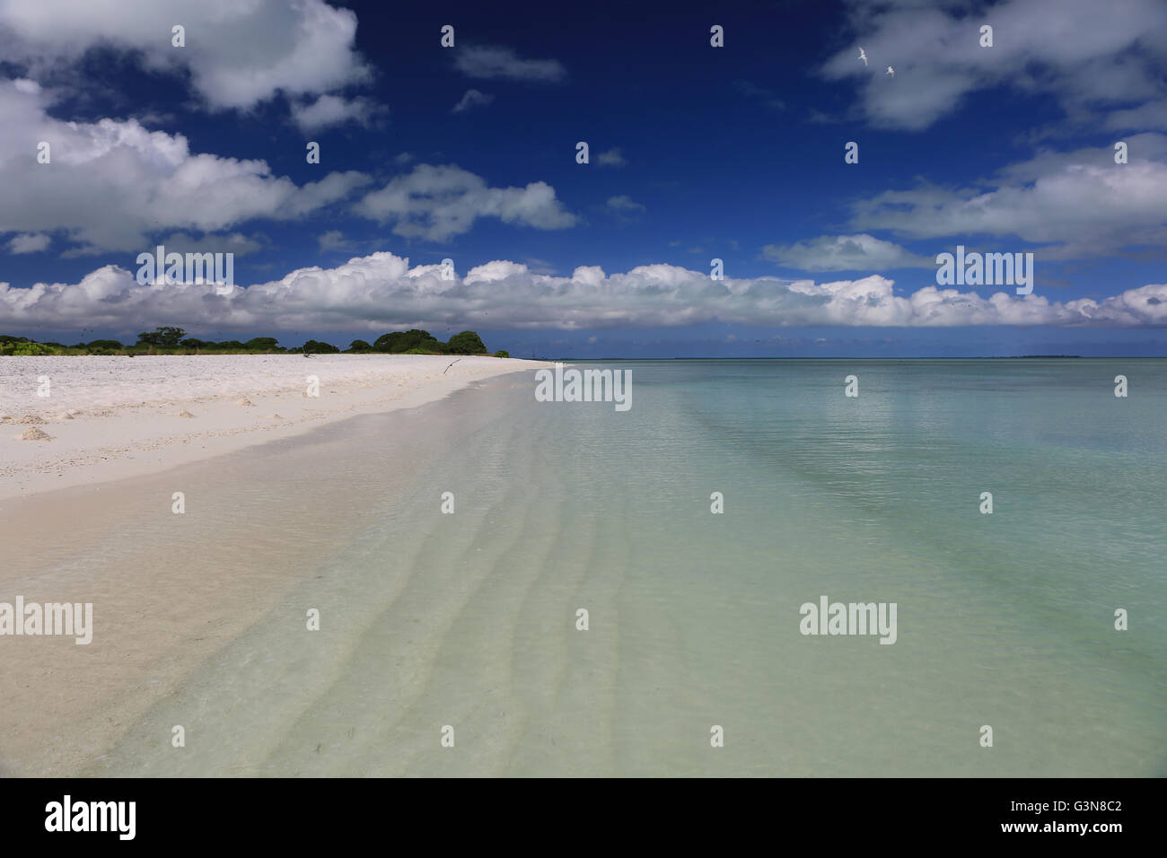 Pristine remote sandy beach in the blue lagoon of Christmas Island ...