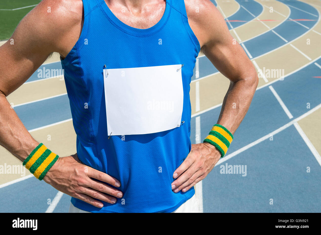 Brazilian athlete in Brazil colored wristbands with blank race bib ...