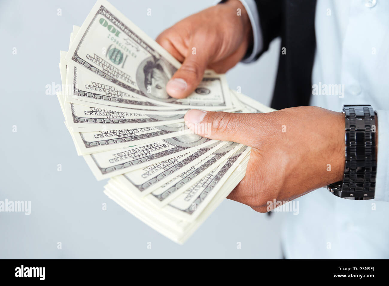 Closeup of hands of african young man holding money Stock Photo - Alamy