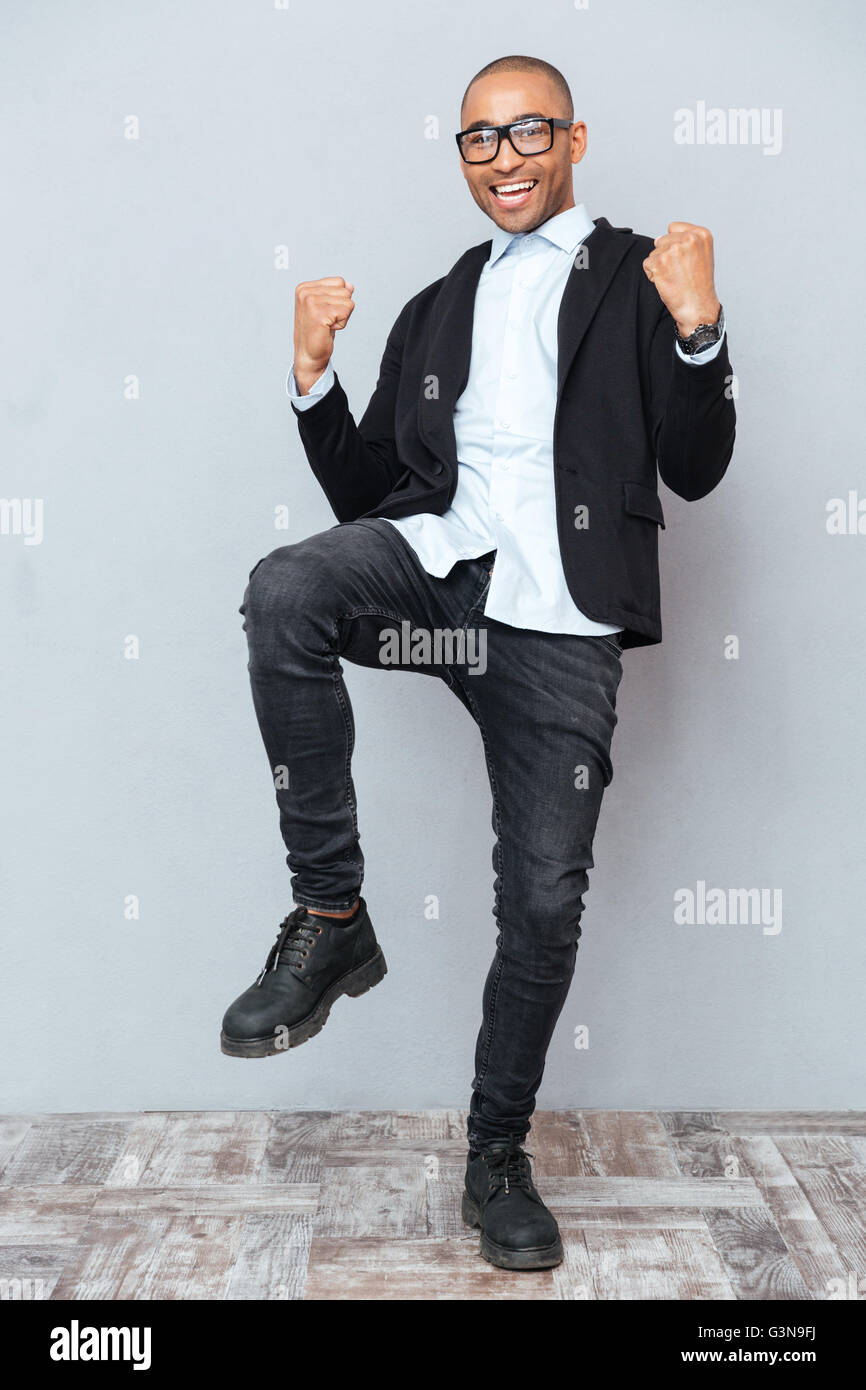 Full length of cheerful african american young man standing and ...