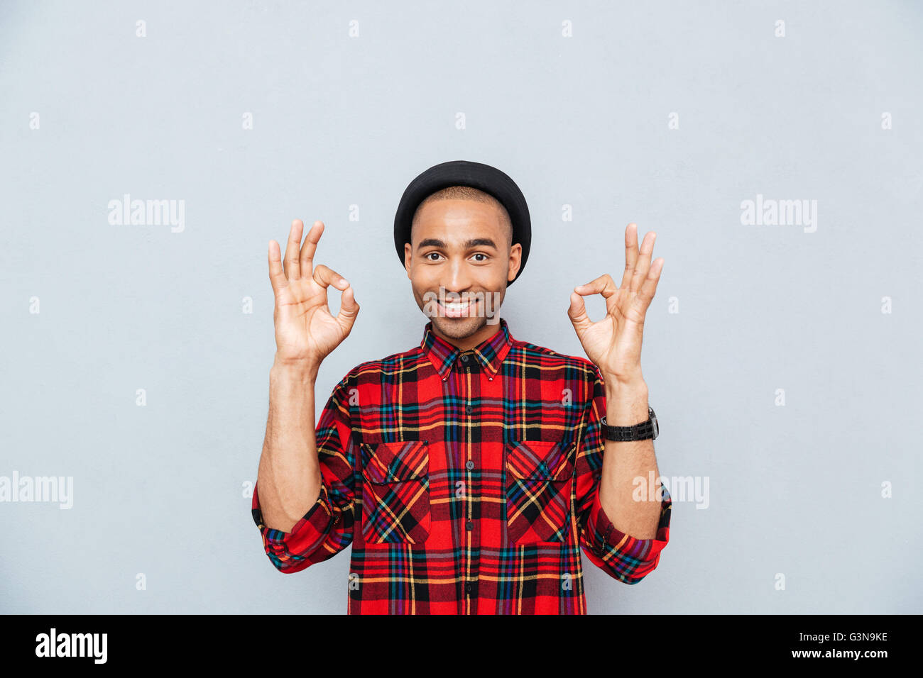 Cheerful attractive african young man showing ok sign Stock Photo - Alamy