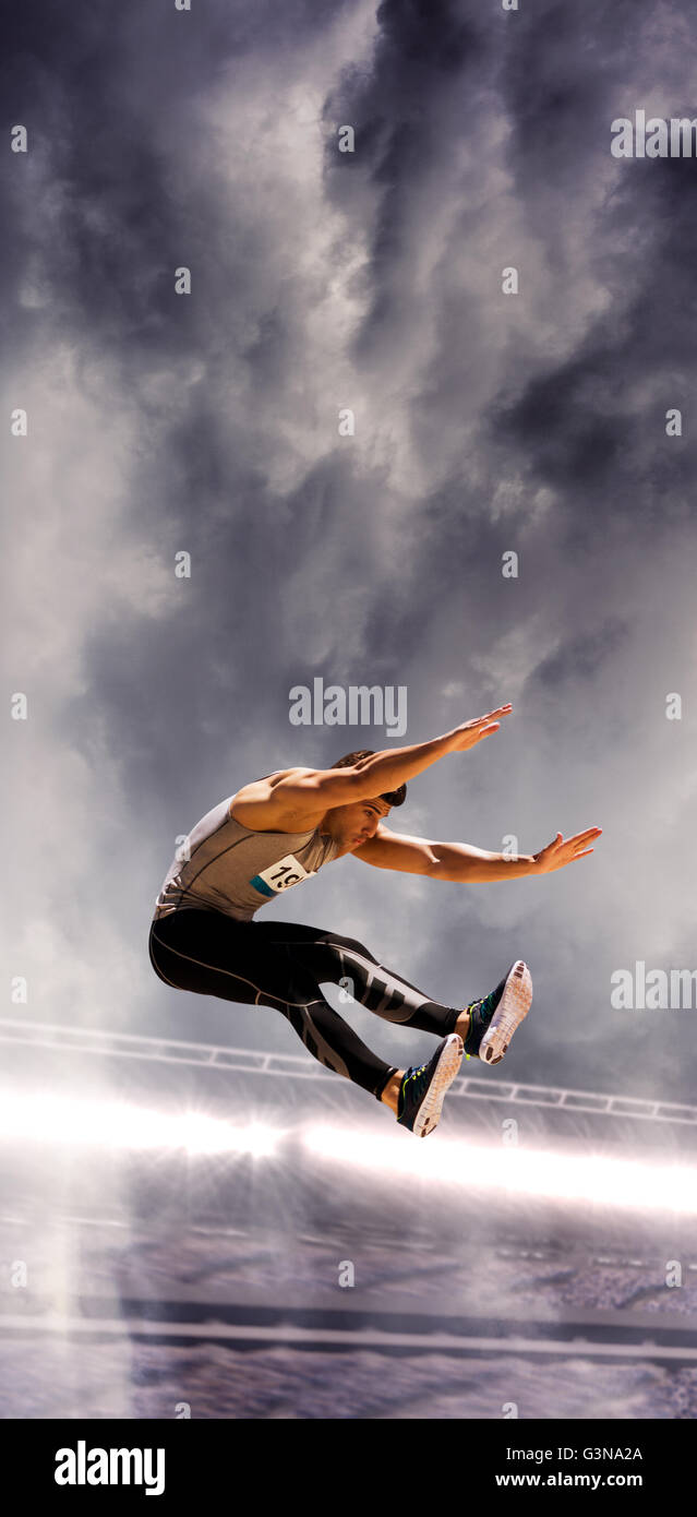 Portrait of sportsman jumping against a stadium Stock Photo - Alamy
