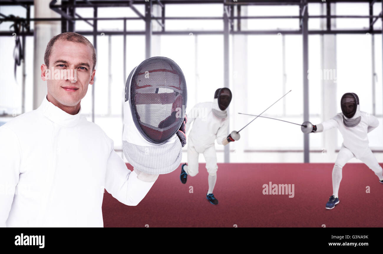 Composite image of swordsman holding fencing mask Stock Photo - Alamy