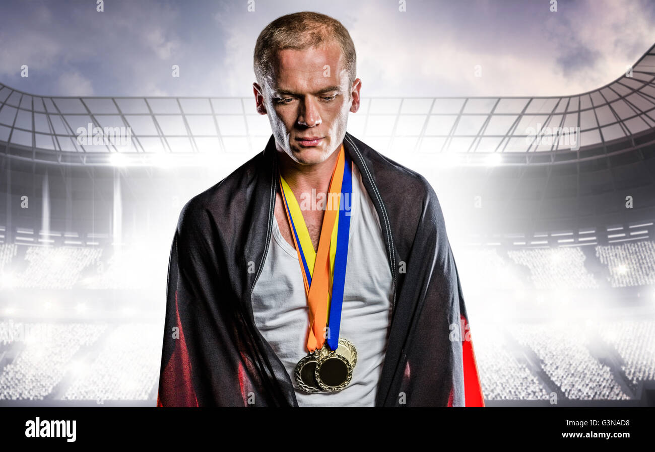 Composite image of athlete with german flag wrapped around his body ...