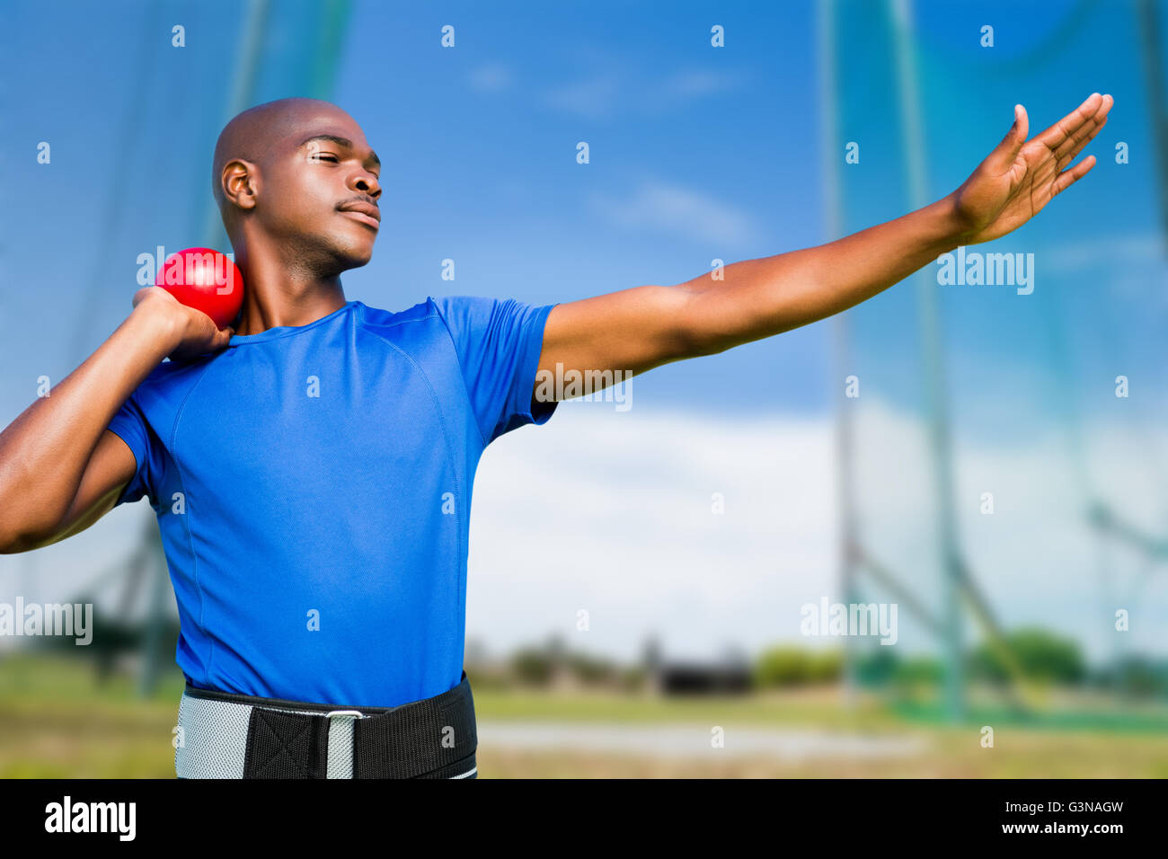 Composite image of front view of sportsman practising shot put Stock ...