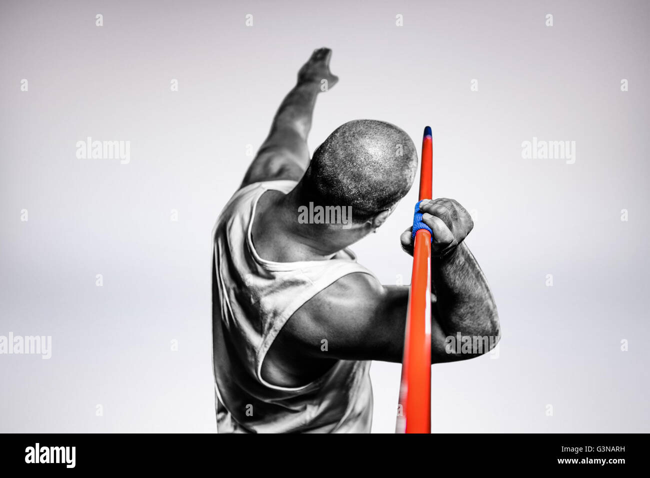Composite image of rear view of athlete preparing to throw javelin ...