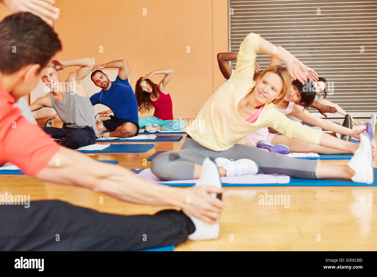 People making stretching exercise in pilates class Stock Photo - Alamy