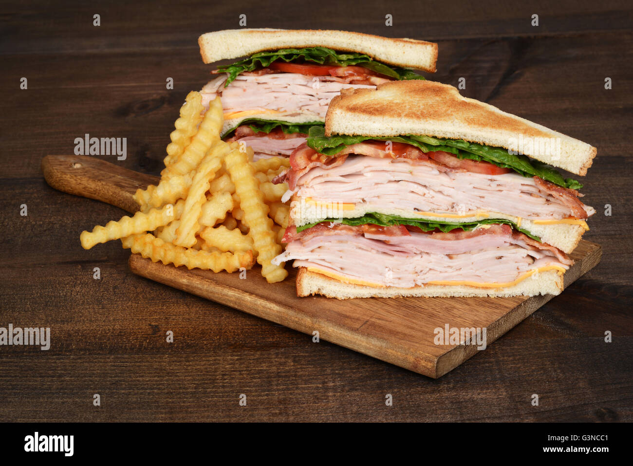 toasted chicken club sandwich with fries Stock Photo - Alamy