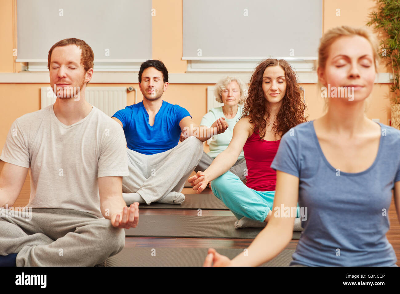 Group making breathing exercise during meditation in yoga class Stock ...