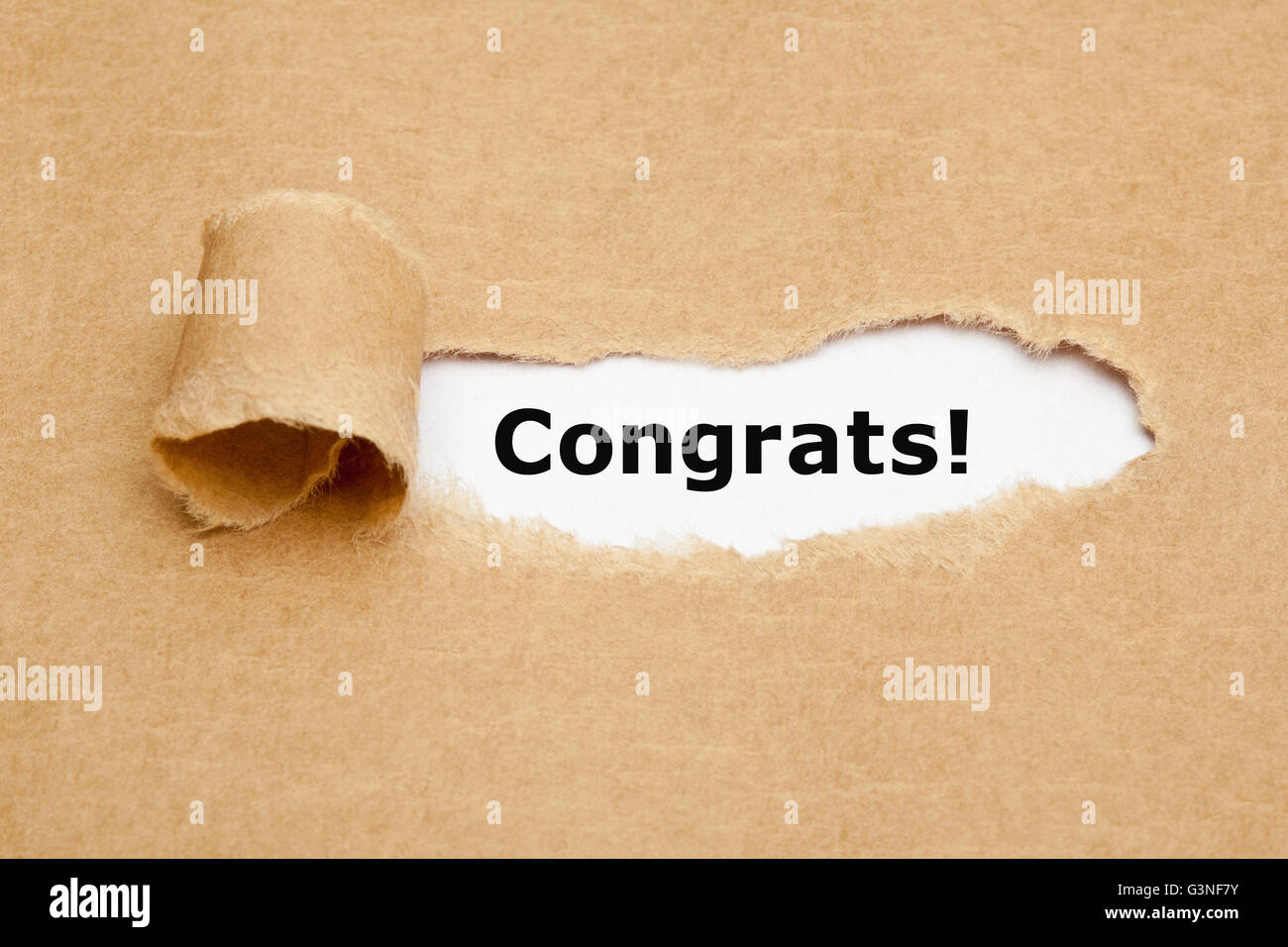 The text Congrats appearing behind torn brown paper Stock Photo - Alamy