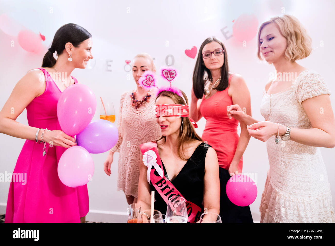 Cheerful bride and bridesmaids celebrating hen party with drinks Stock ...