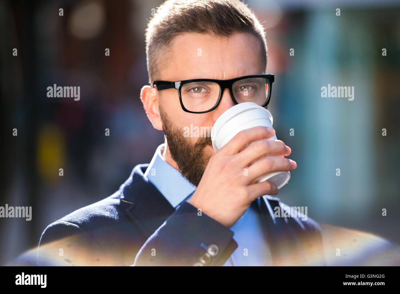 Businessman drinking coffee in the street of London Stock Photo - Alamy