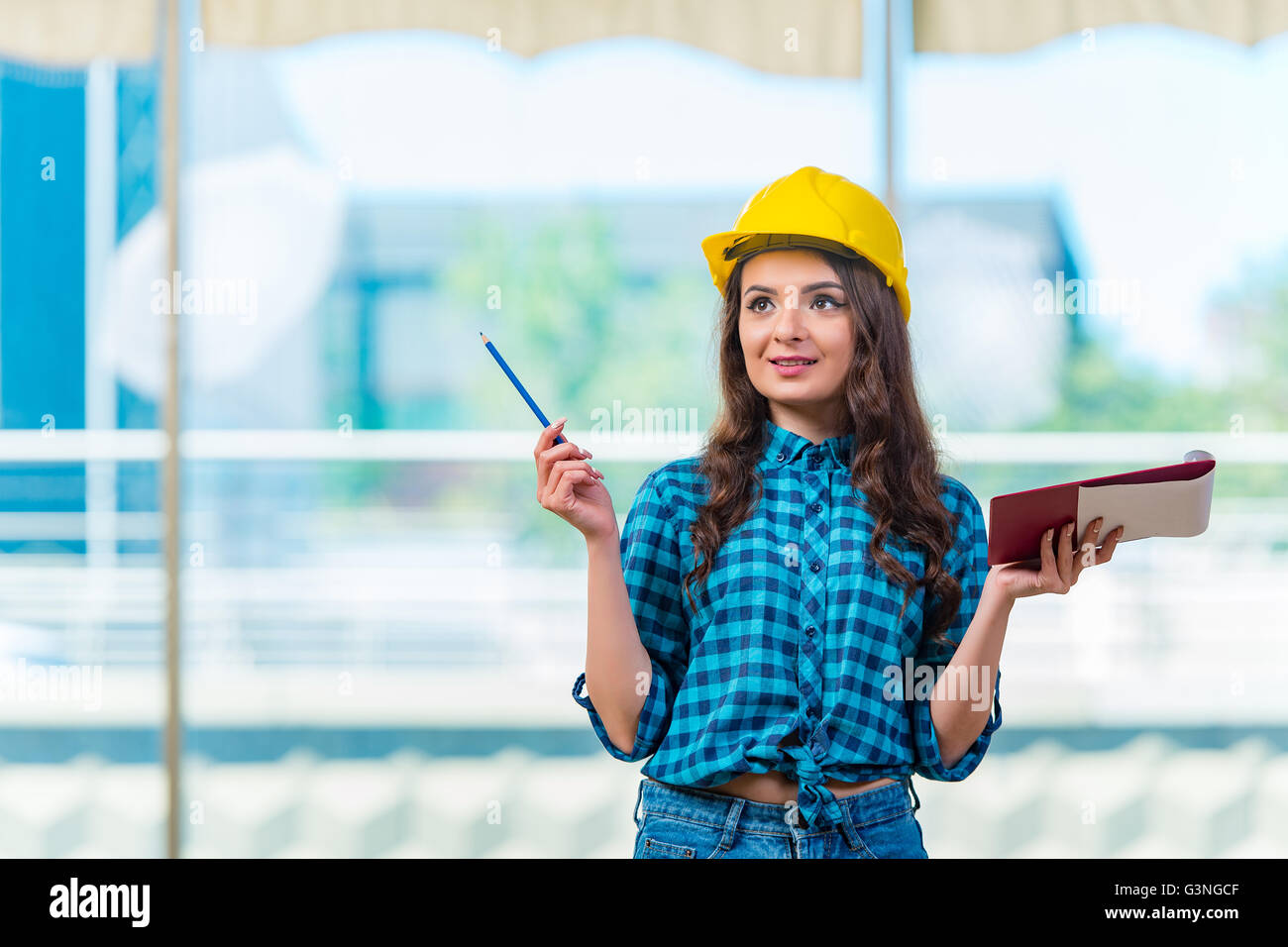 Woman builder taking notes at construction site Stock Photo - Alamy